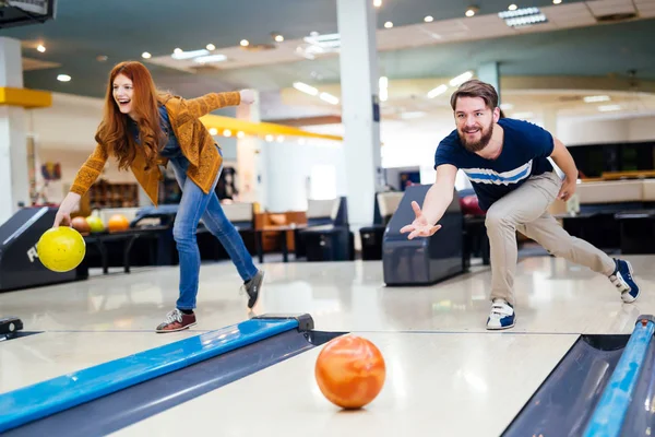 Happy friends having fun and enjoying playing bowling together - Stock ...