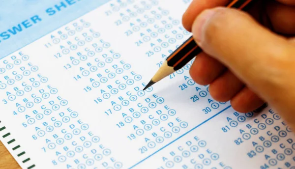 Moving Blur Hand Marking Answer Sheet Stock Photo by ©lamaip 207600634