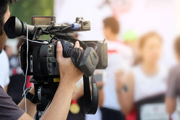 Photographer video recording activity within the event - Stock Image ...