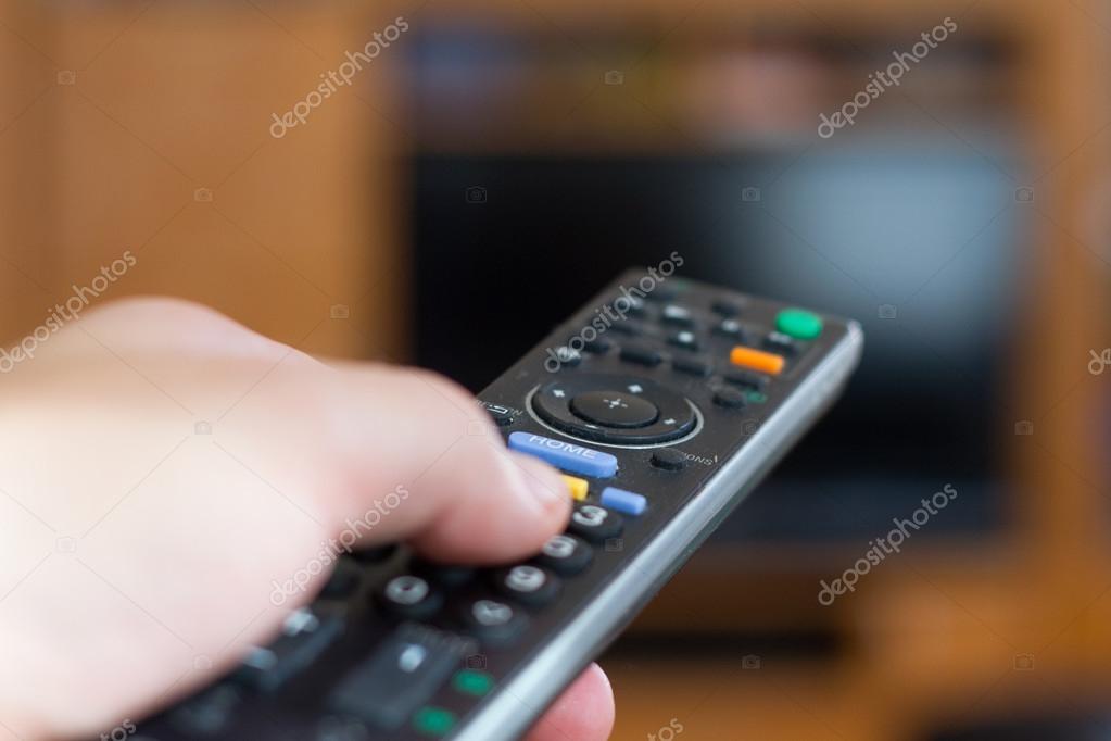 Watching tv, television remote control, controller in hand Stock Photo ...