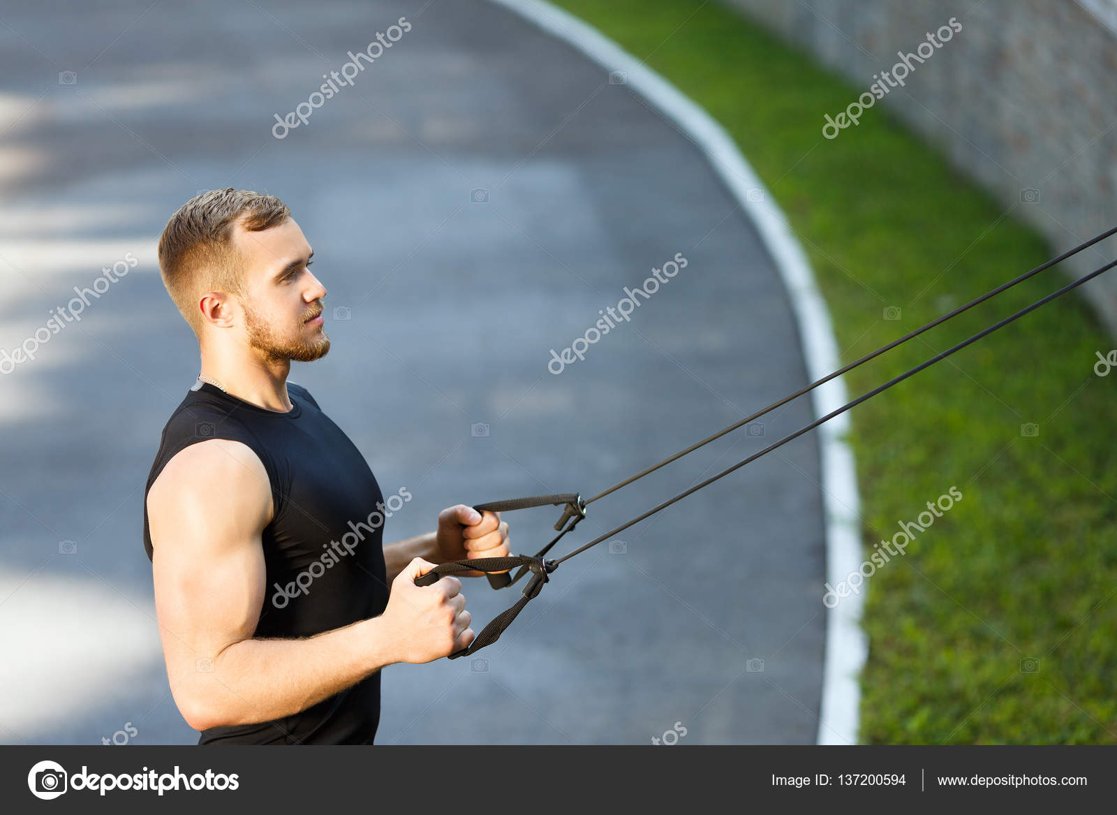 Muscular man pulling expander — Stock Photo © VelesStudio #137200594