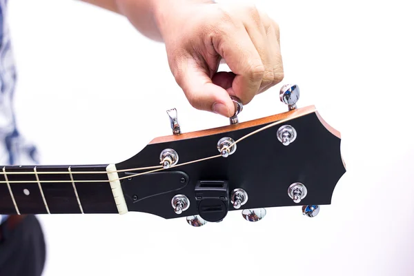 Person tuning a guitar - Stock Image - Everypixel