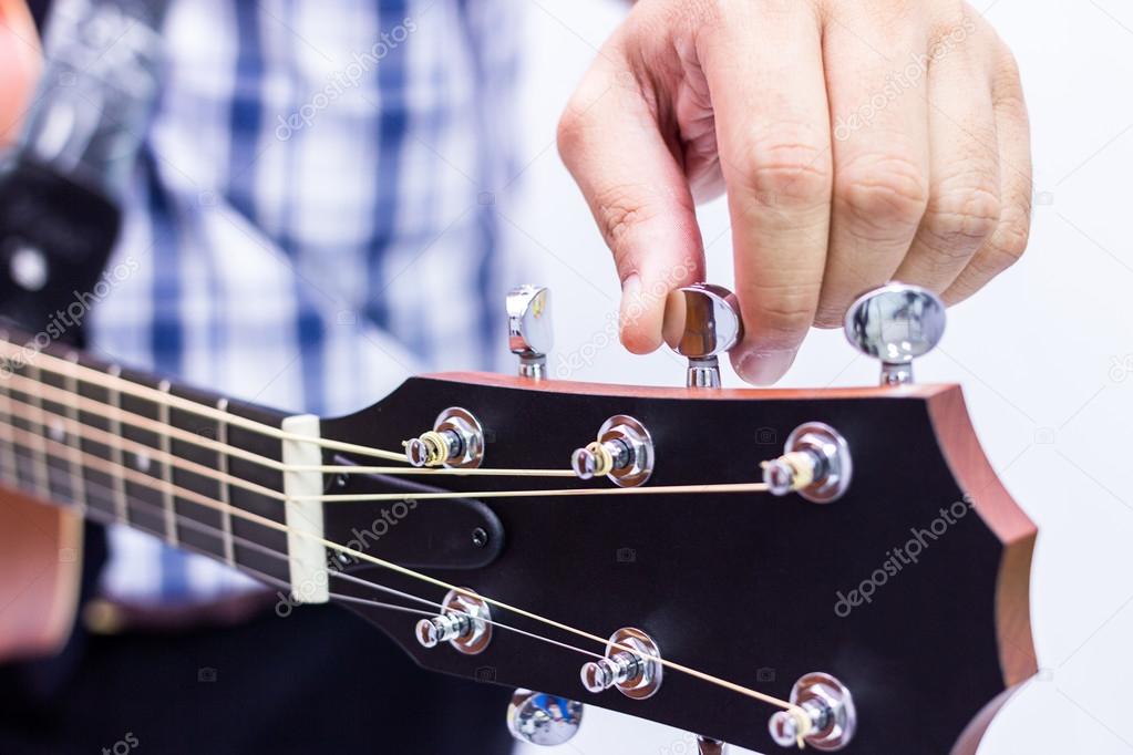 Person tuning a guitar Stock Photo by ©aona2303 125996946