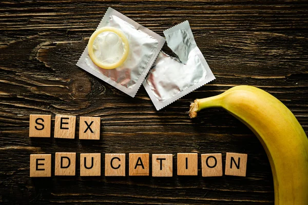 Sex education concept - banana in condom on pastel background Stock ...