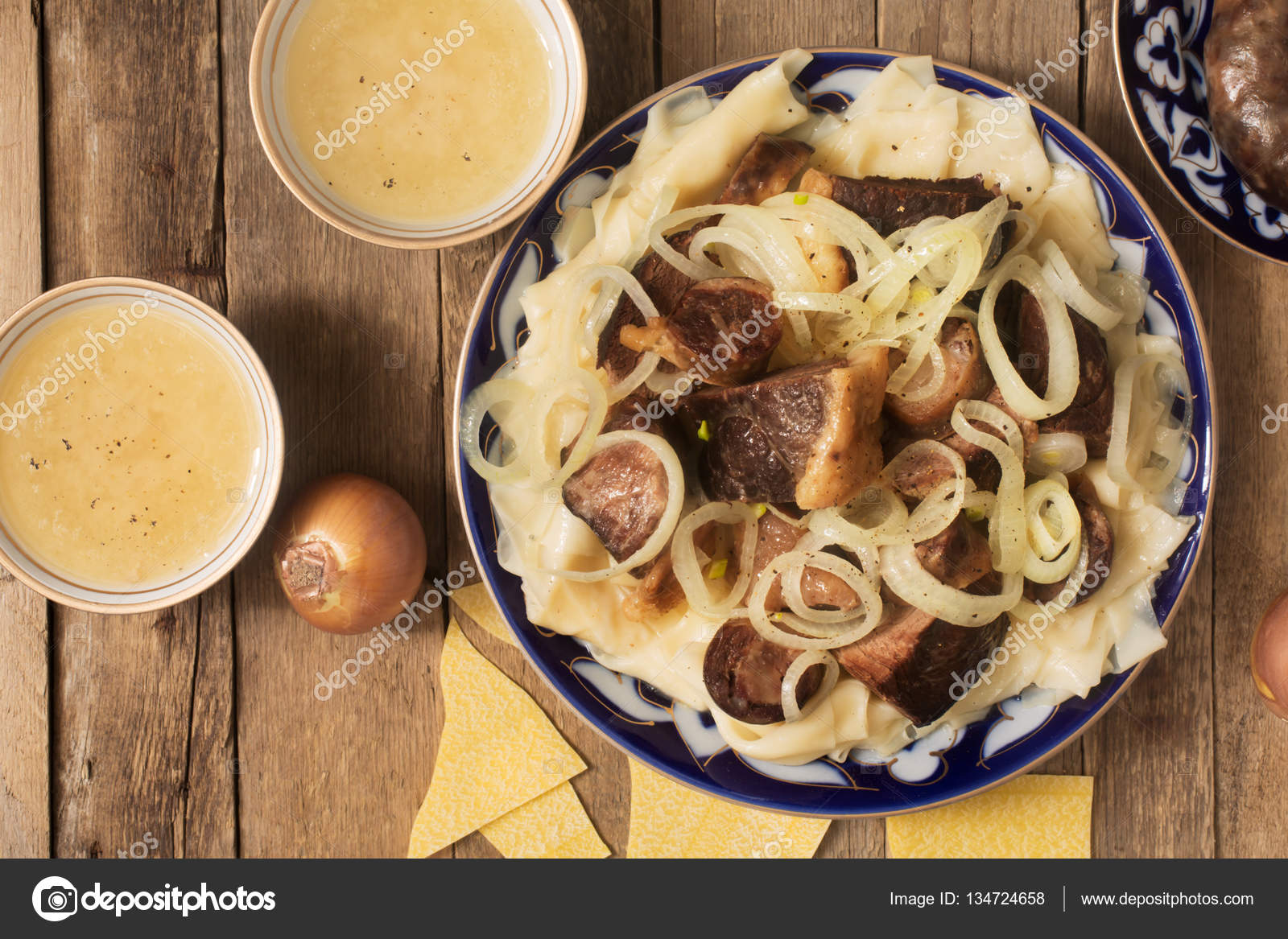 National Kazakh dish - Beshbarmak and bouillon in the bowls Stock Photo ...