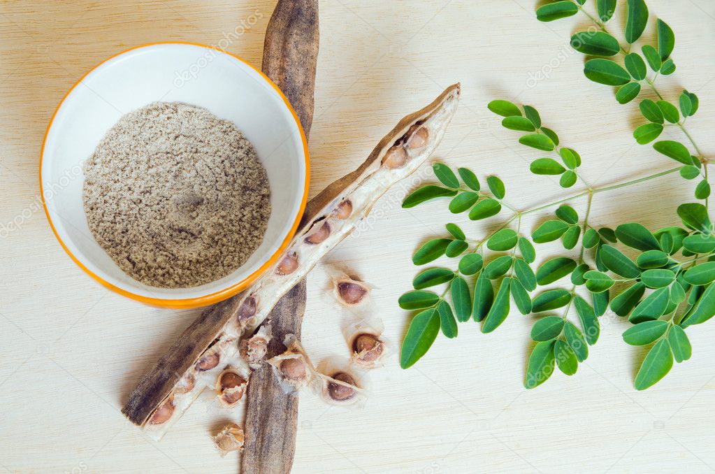 Moringa leaf and Moringa seed on wooden board background Stock Photo by ...