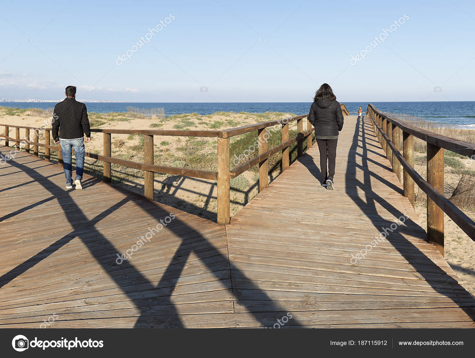 Couple going by different path on a wooden walkway in Arenales d ...
