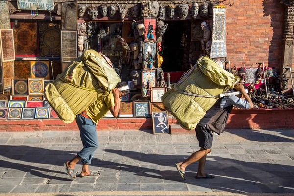 Porters carrying heavy loads on their back, annapurna, nepal – Stock ...