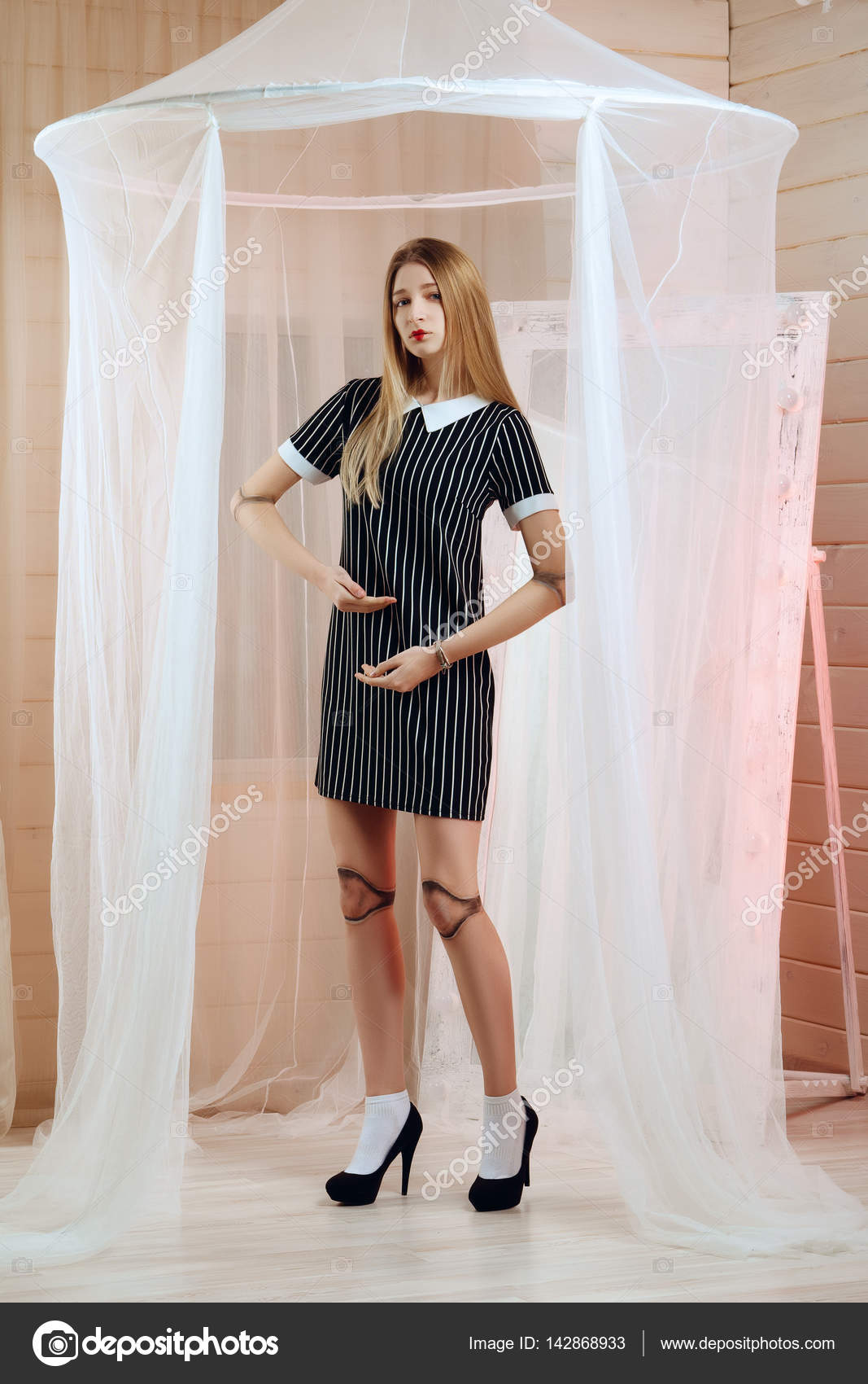 Pretty girl in puppet look body paint. Young lady acts and posin ...