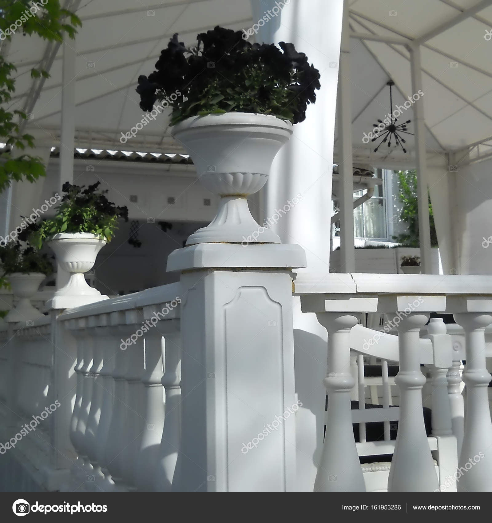 Railing with decorative balusters and pot with flowers . — Stock Photo ...