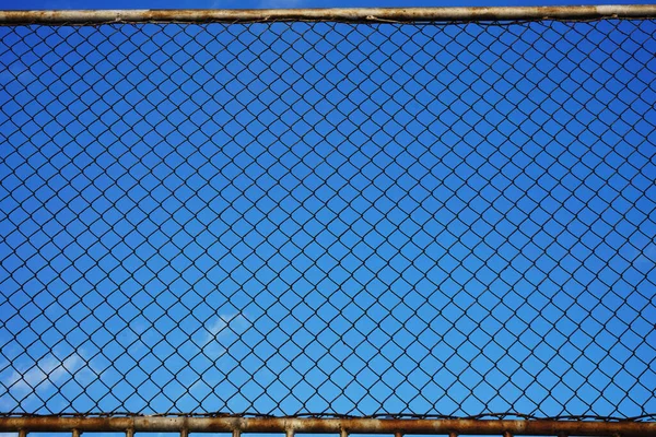 Fence on a blue sky, Mesh fence with partly cloudy sky, Chain link ...