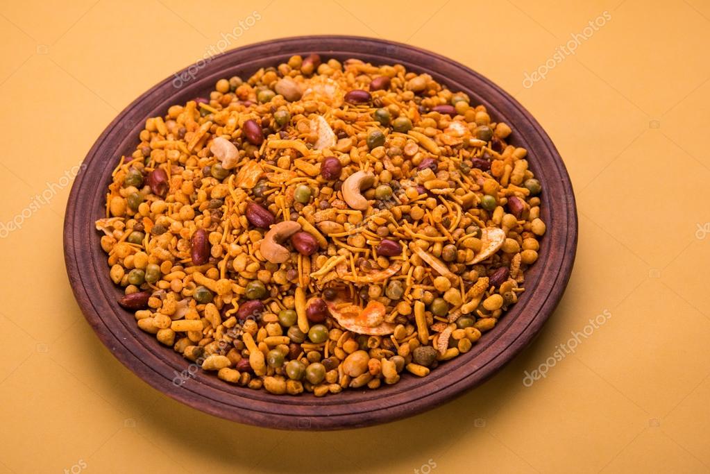 Indian famous snack called Farsan or chivada or chakna with hot tea ...