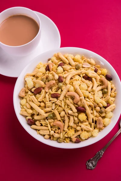 Indian famous snack called Farsan or chivada or chakna with hot tea ...