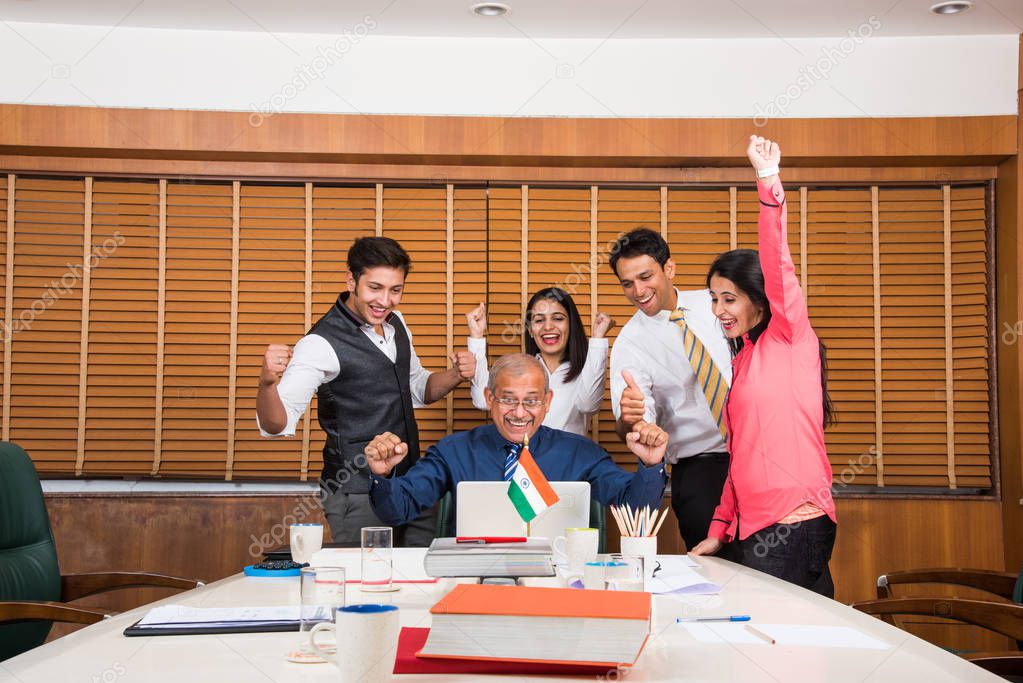 Indian business people enjoying success in conference room with ...