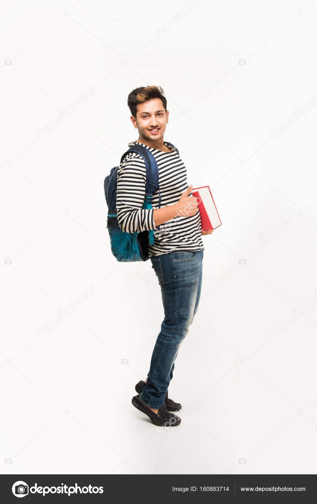 Handsome and young indian Male college student carrying bag on white ...