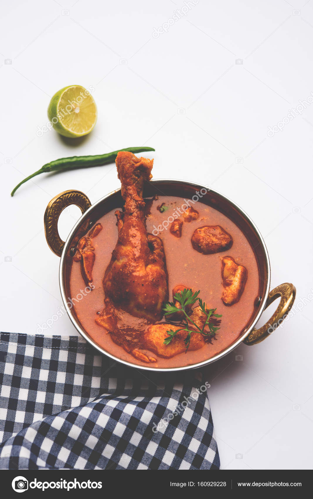 Indian spicy Chicken curry or masala chicken with prominent leg piece ...