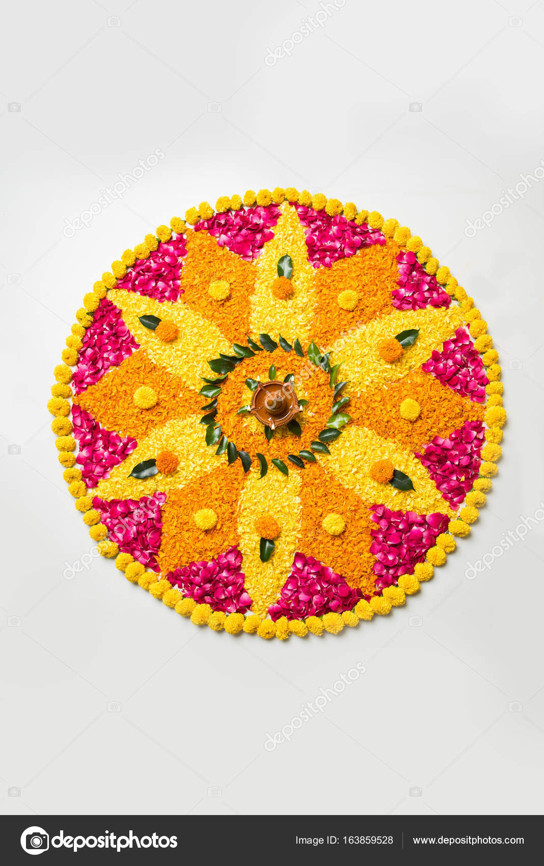 Flower rangoli for Diwali or pongal made using marigold or zendu ...