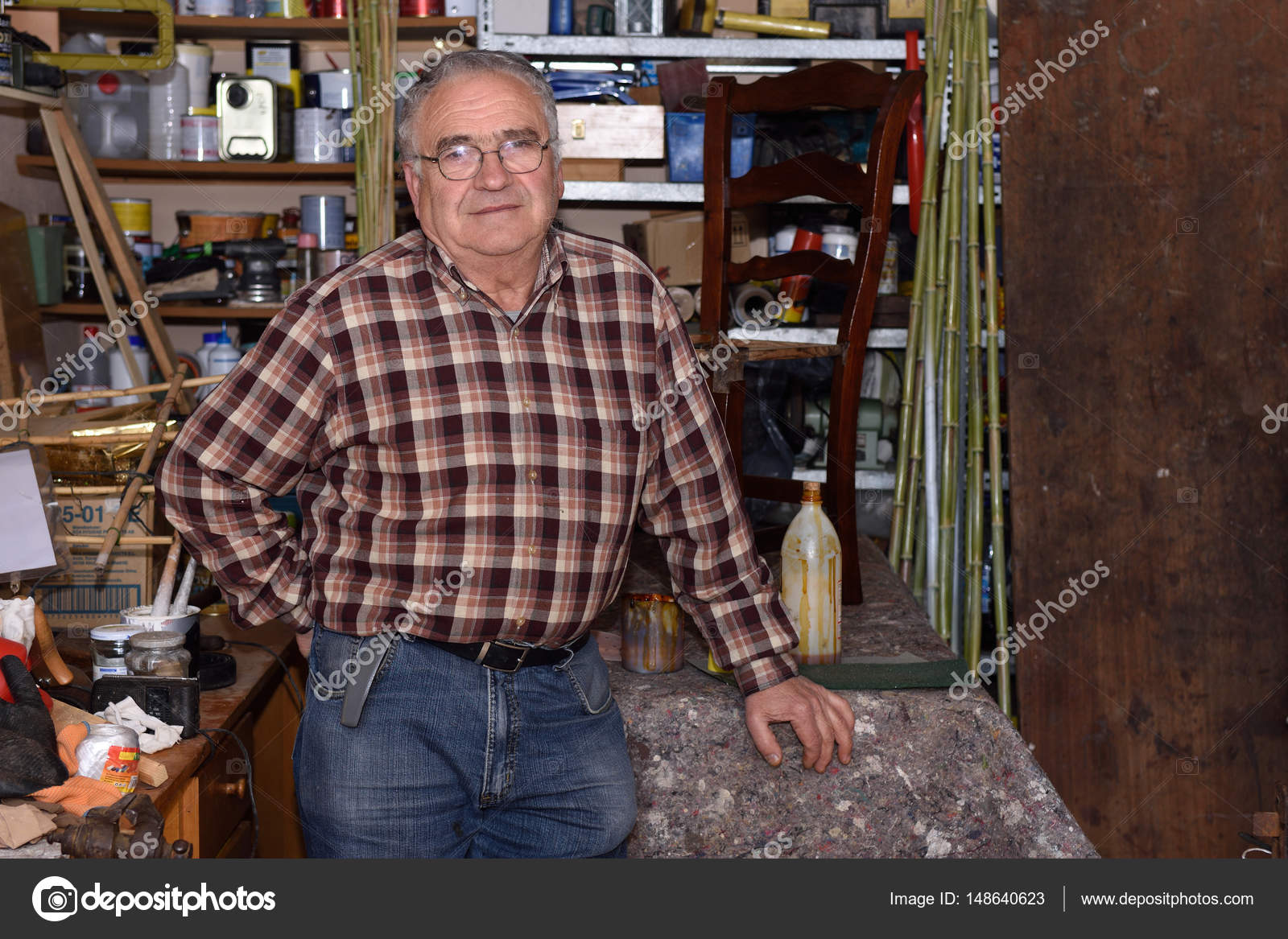 Portrait of a retired carpenter in his workshop — Stock Photo © MariaiC ...