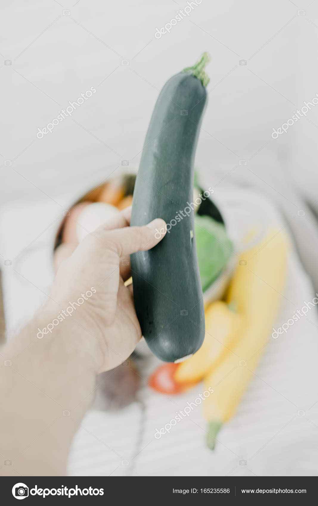 Zucchini in vegan man hand Stock Photo by ©smakashin 165235586