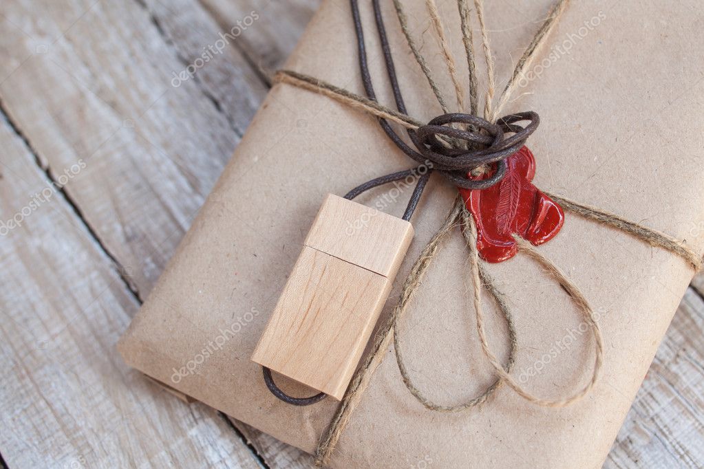 The parcel wrapped in Kraft on a wooden background. Stock Photo by ...