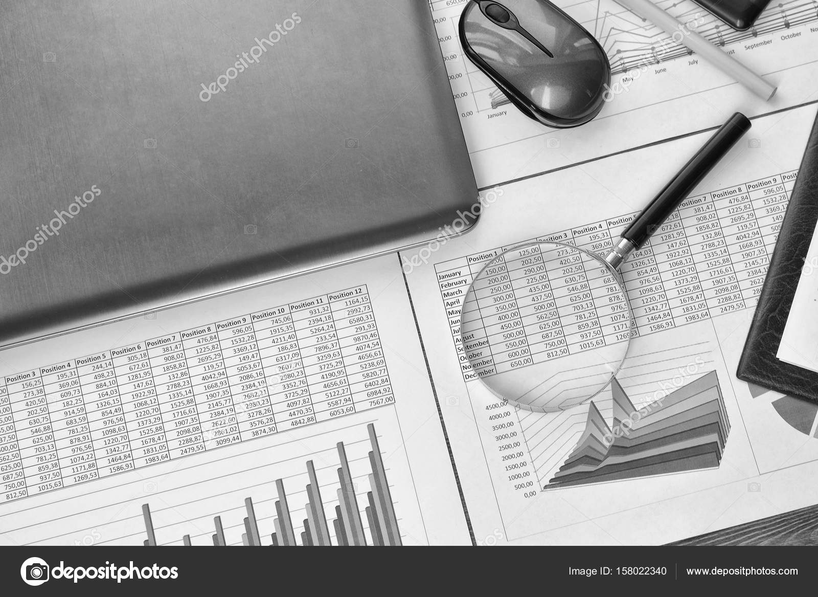 Financial printed paper charts, graphs, diagrams, computer, pen, and ...