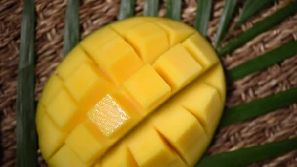 Sliced mango on rotating background. Top view. Exotic fruit, tropical ...
