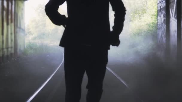 Slow motion man running away on train track. Back view. Abstract ...