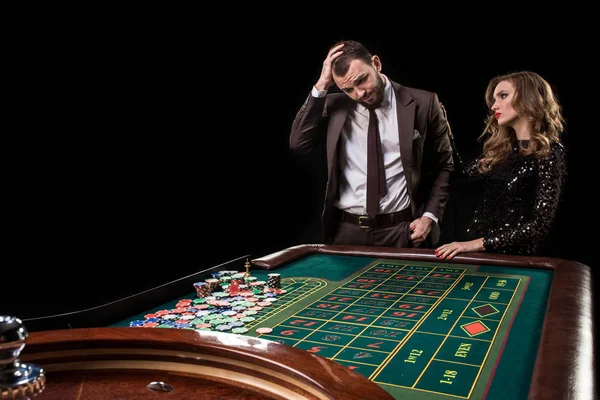 Man and woman playing at roulette table in casino - Stock Image ...