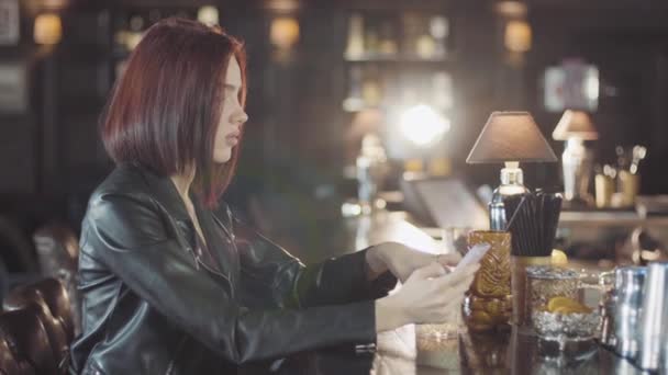 20s Sexy Beauty Redhead Woman In Black Leather Jacket Is Drink Cocktail Looking At Camera And