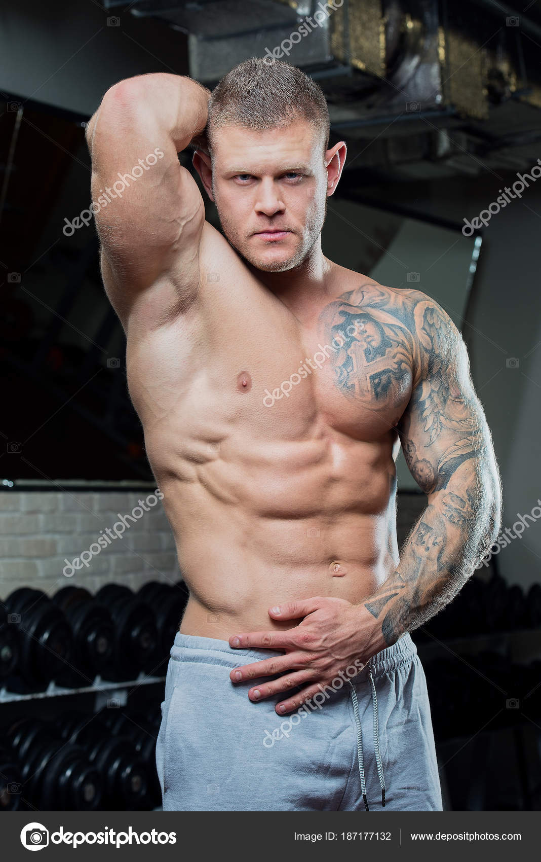 Muscular Shirtless Strong Man Blue Eyes Tattoo Poses Gray Pants Stock ...