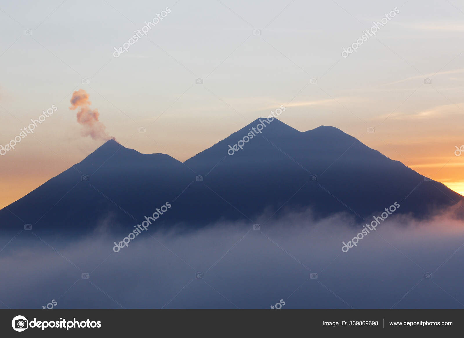 Puesta de sol con nubes que rodean el Volcán de Fuego y el volcán ...