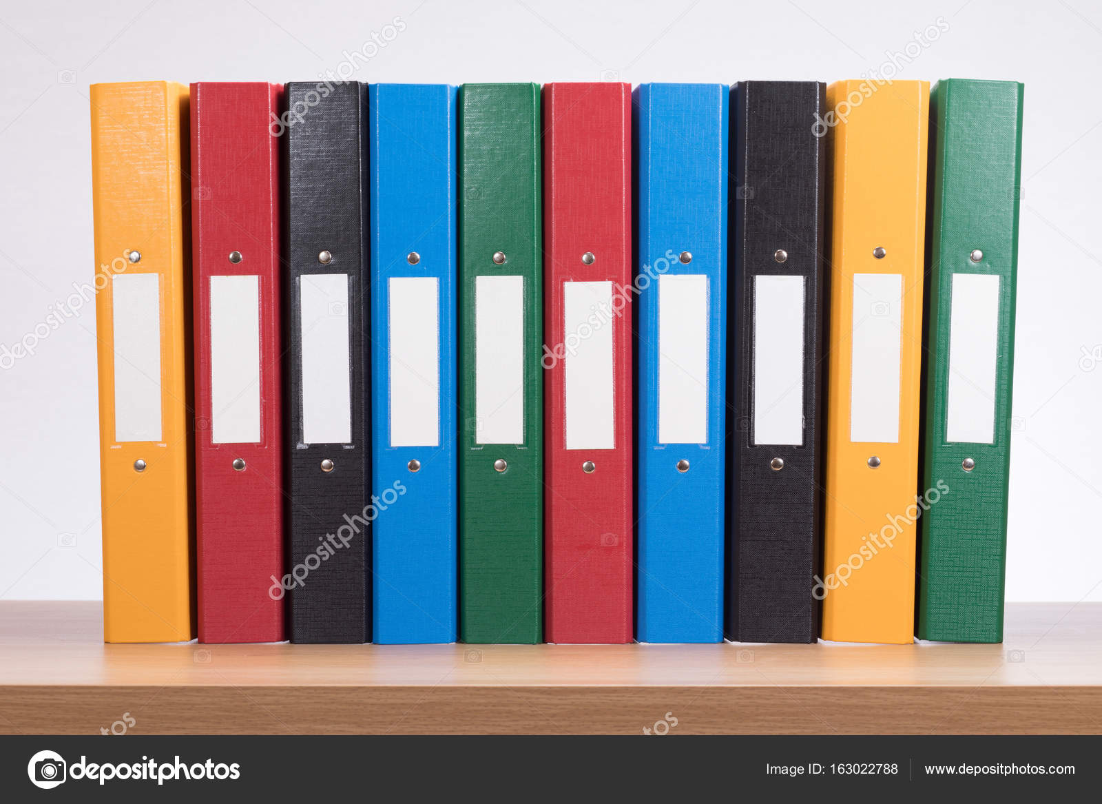 Row of coloured office document folders on shelf Stock Photo by ...