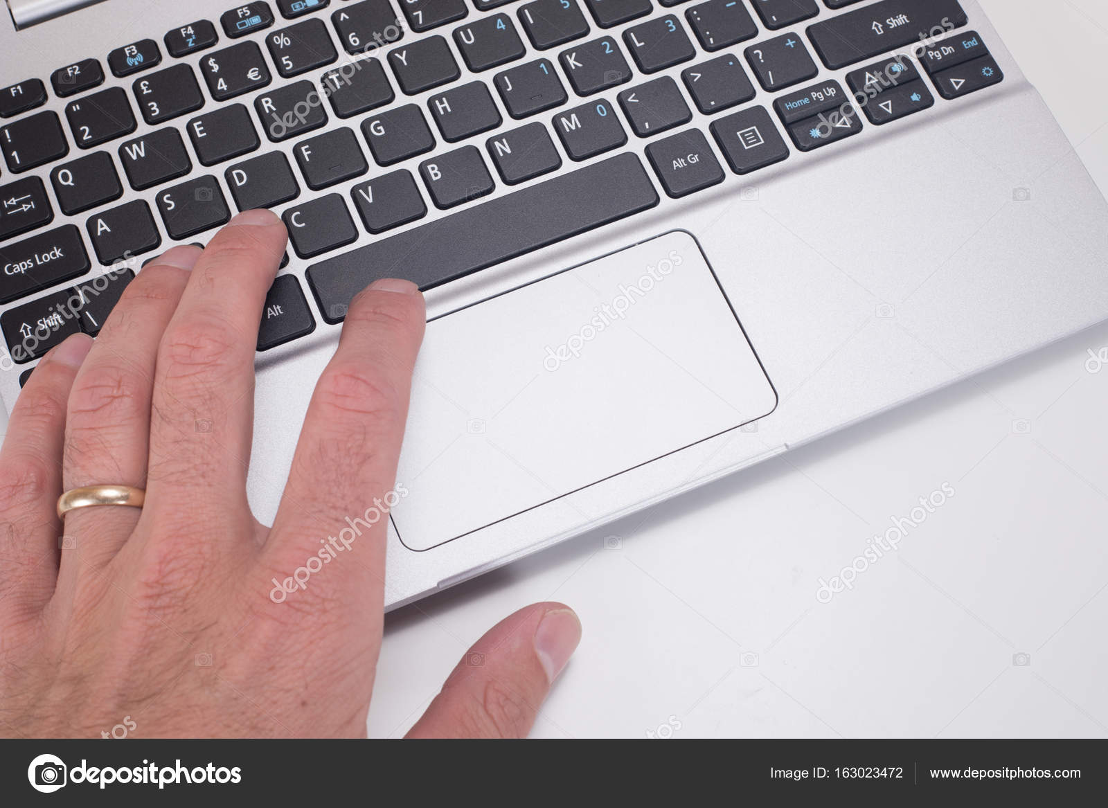 Human hand with ring using laptop keyboard Stock Photo by ©mattkusb ...