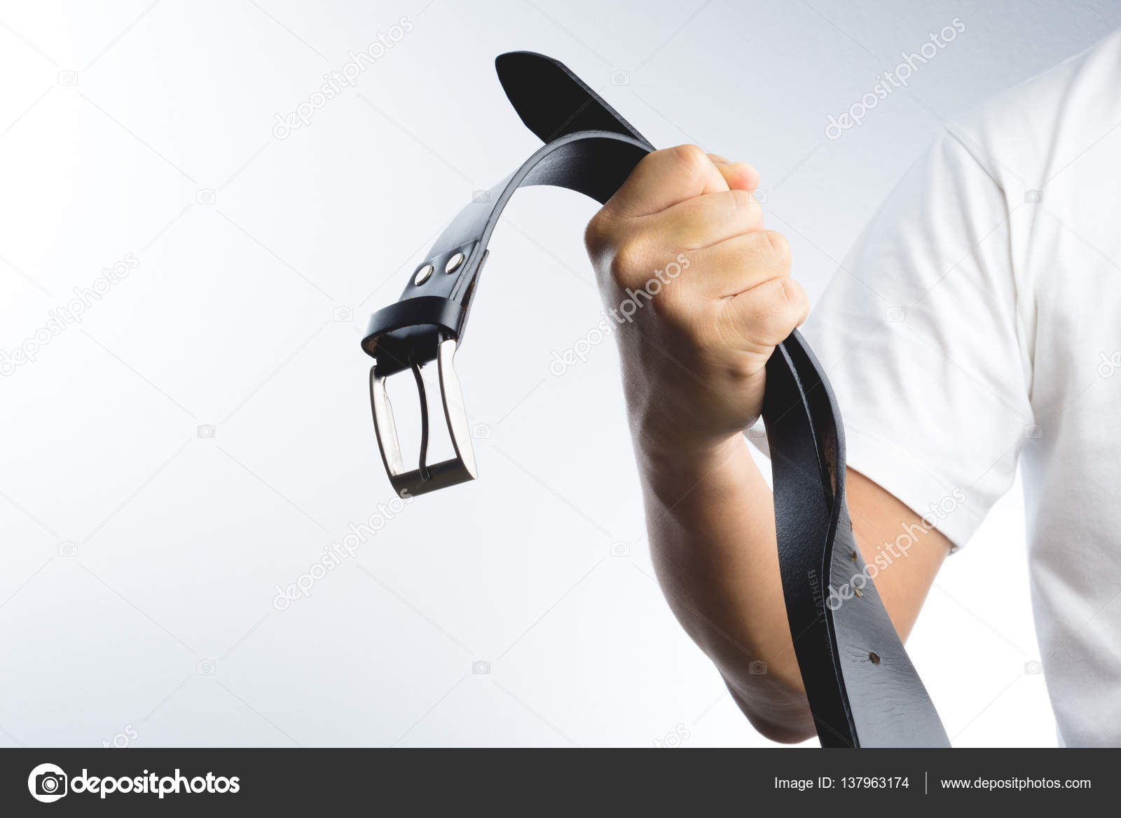 Hand holding leather belt for punishment, family violence conce Stock ...