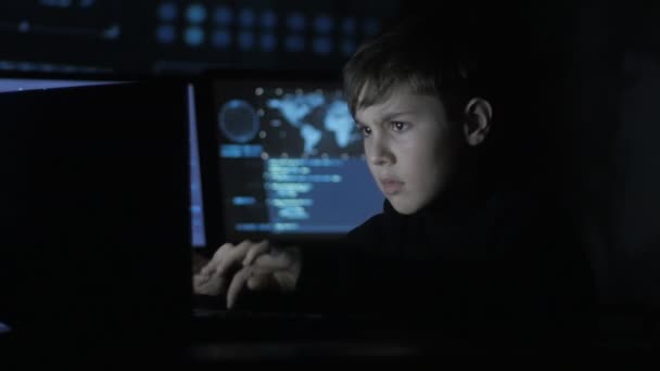 Cute teen Boy hacker programmer is working on computer in cyber ...