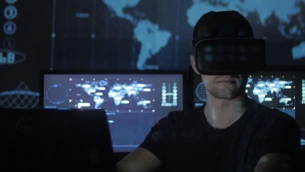 Man hacker programmer uses a virtual reality helmet for programming. IT ...