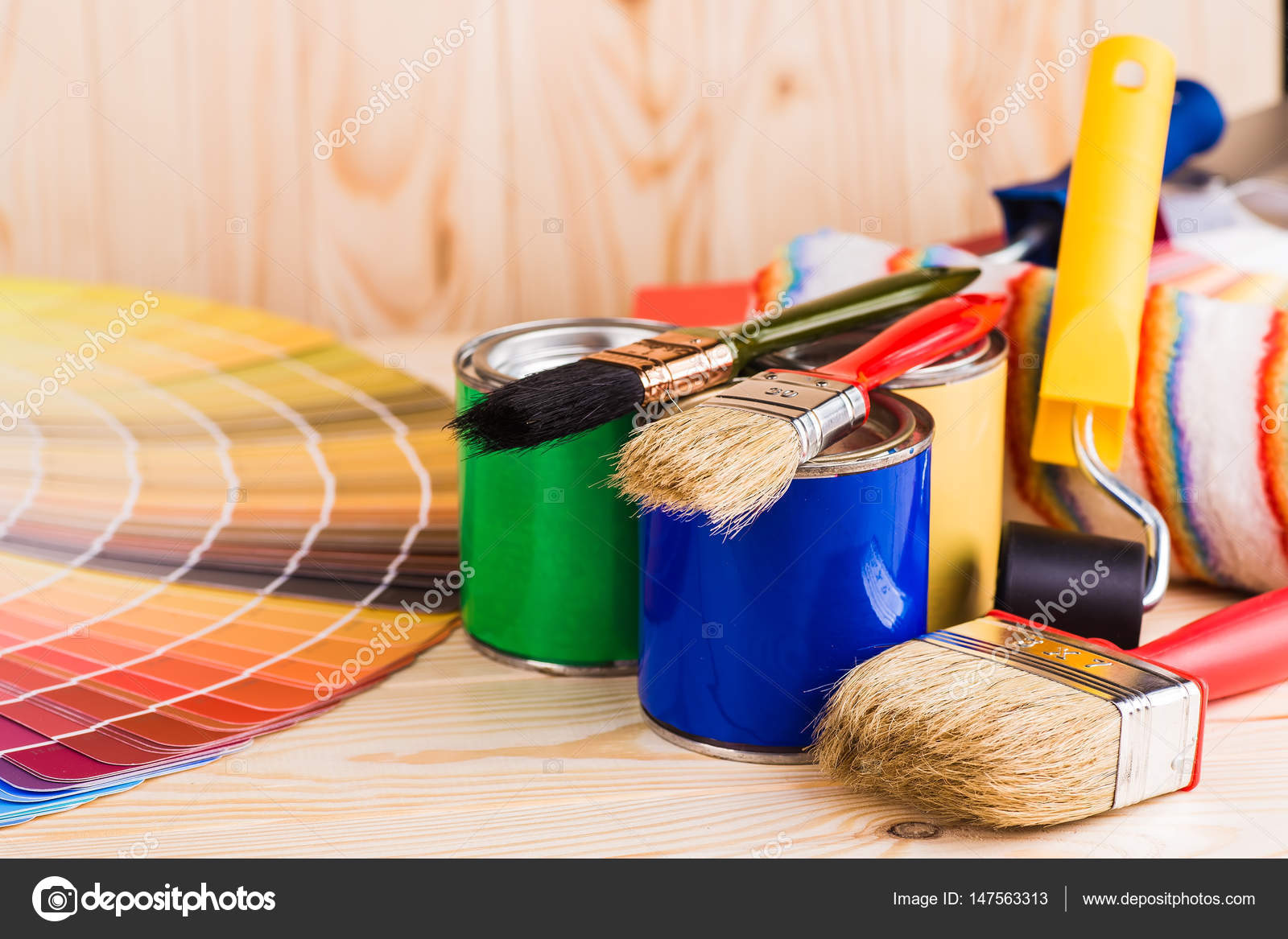 Painter and decorator work table with house project, color swatc ...