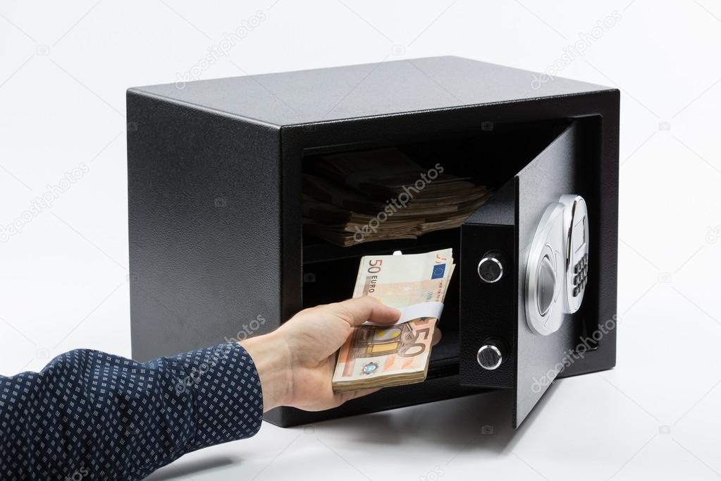 Male hand keeping euro banknotes in a safe deposit box Stock Photo by ...