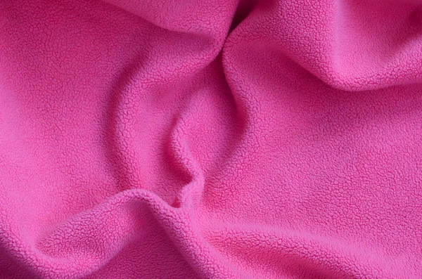 The blanket of furry pink fleece fabric. A background of light pink ...