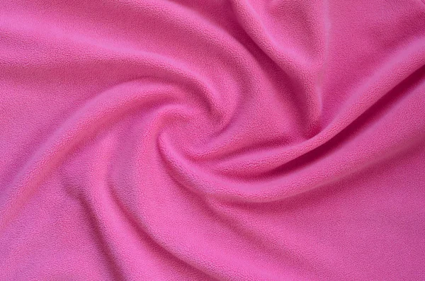 The blanket of furry pink fleece fabric. A background of light pink ...