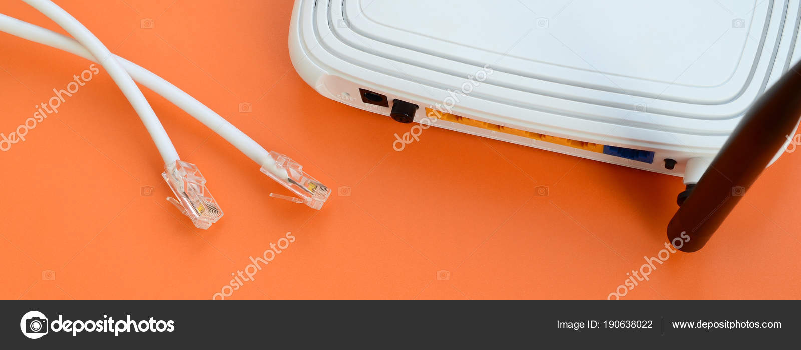 Internet router and Internet cable plugs lie on a bright orange Stock ...