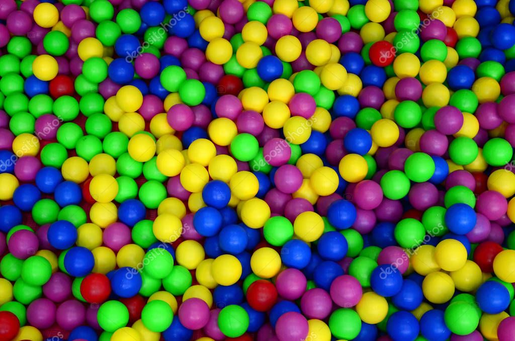 Muchas bolas de plástico de colores en una bola de niños en un patio de ...
