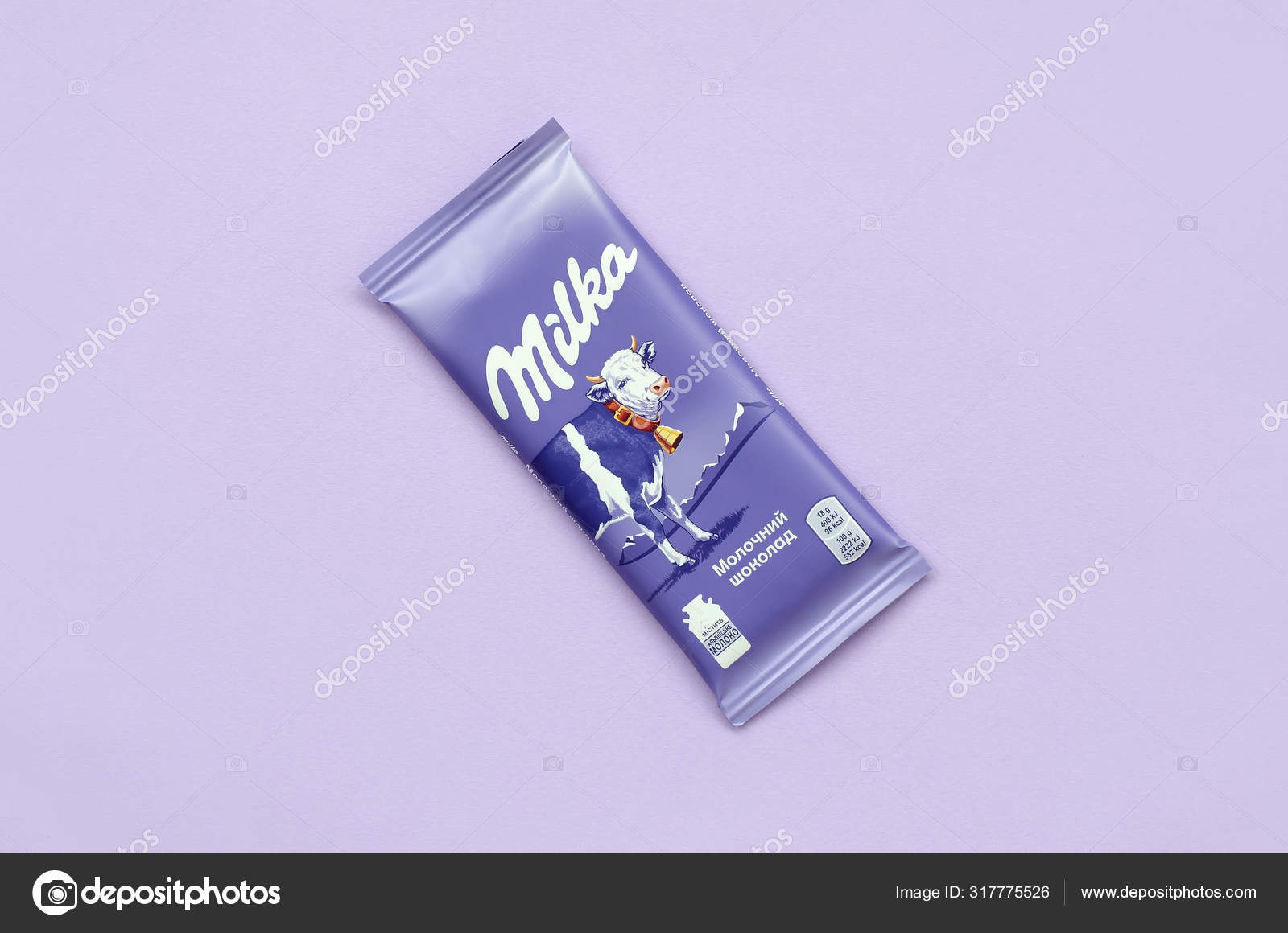 Milka chocolate tablet in classic violet wrapping on lilac background ...