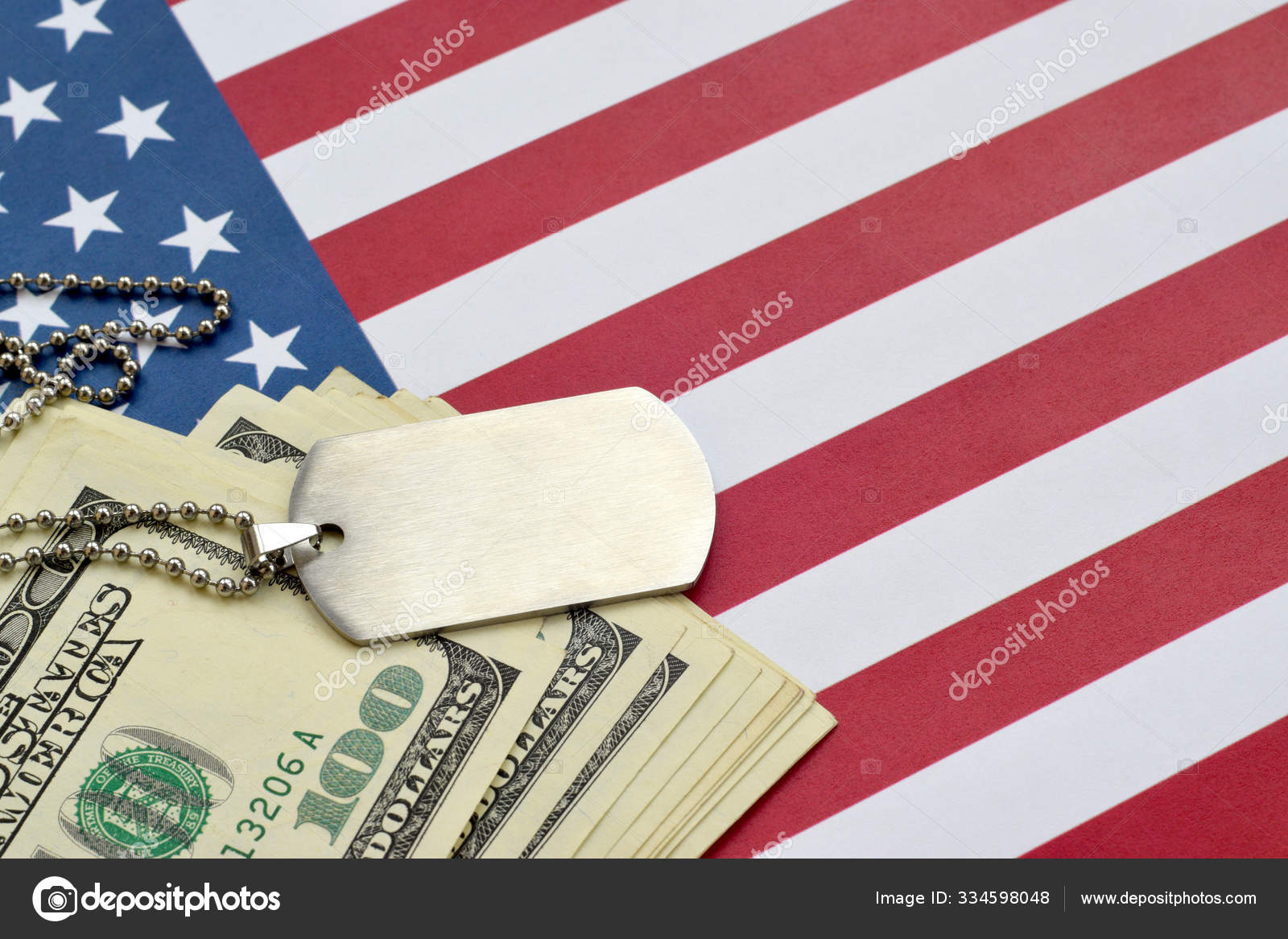 Army identification medallions and dollar bills on United states flag ...