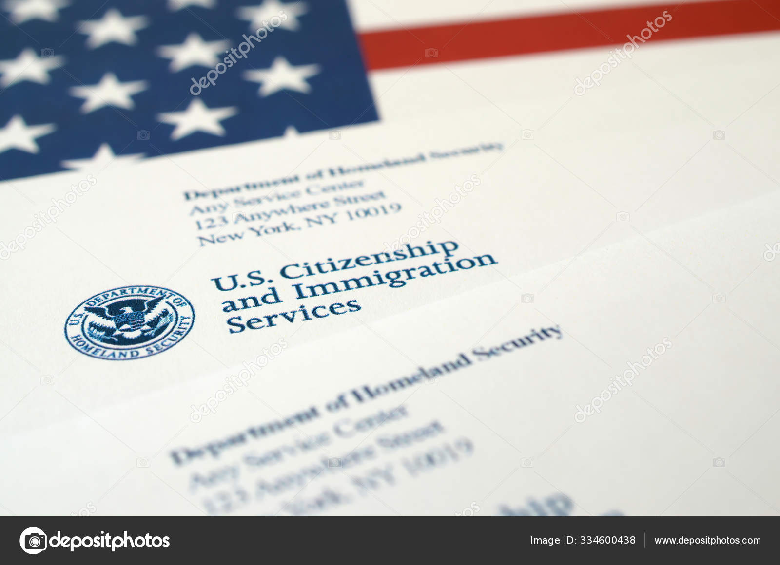 Envelopes with letter from USCIS on United States flag from Department ...