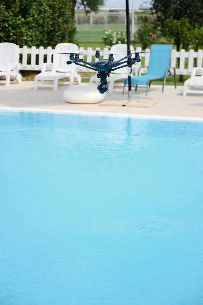 Girl fly drone with remote control by the swimming pool Stock Photo by ...