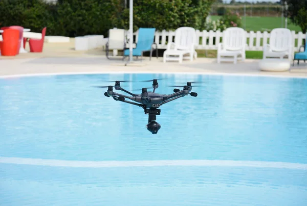 Girl fly drone with remote control by the swimming pool Stock Photo by ...