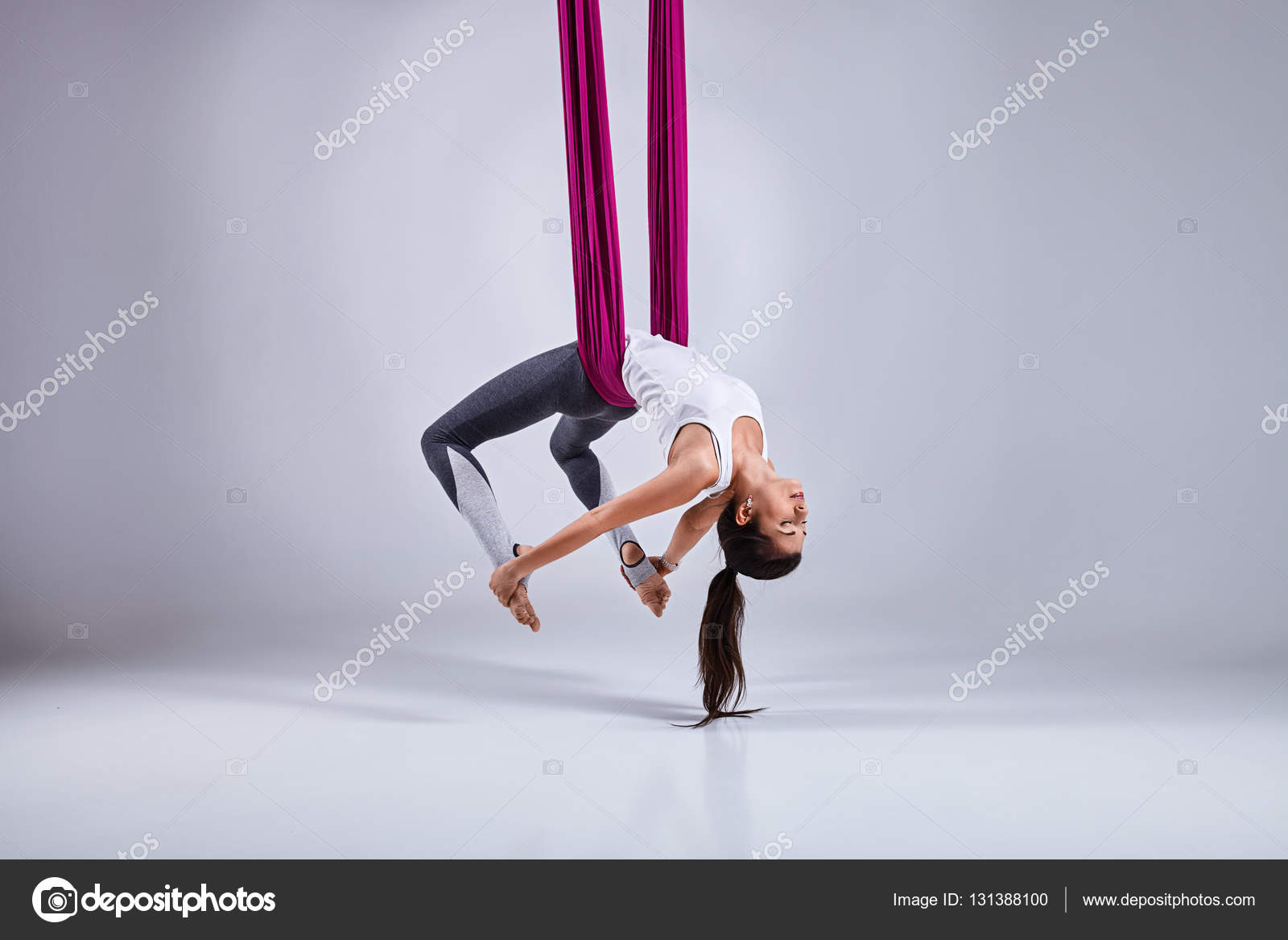 Aerial different inversion antigravity yoga in a hammock Stock Photo by ...