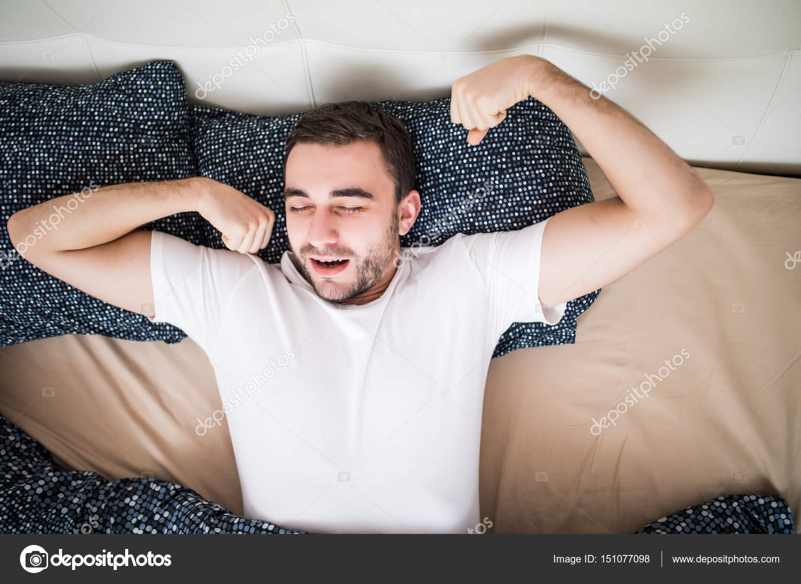 Young handsome happy man waking up on bed at home, top view — Stock ...