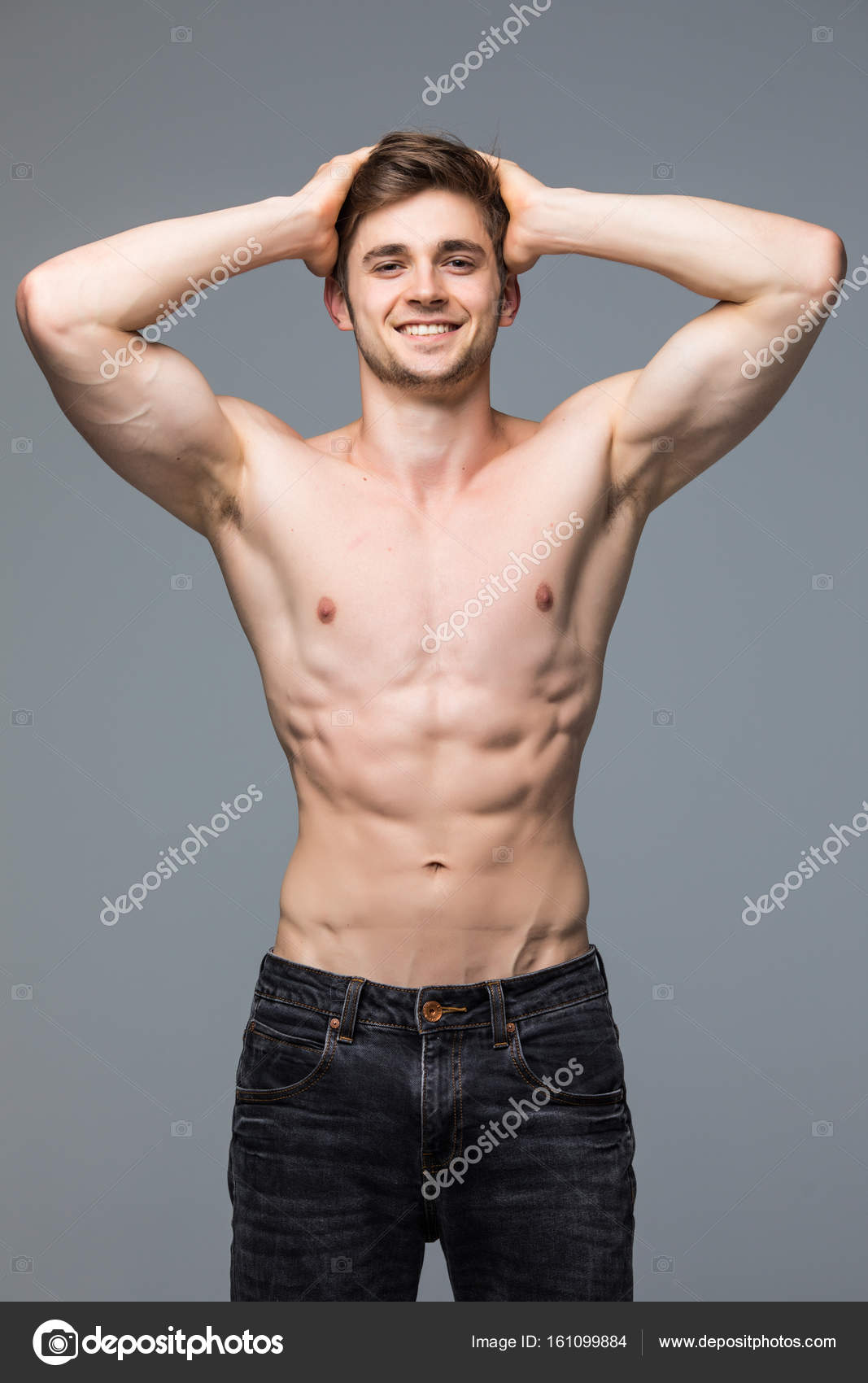 Young pretty handsome man with muscle torso on gray background — Stock Photo © dan.grytsku.gmail ...